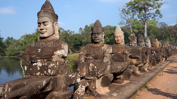 the row of stone statues that line the walkway over the lake are all ...