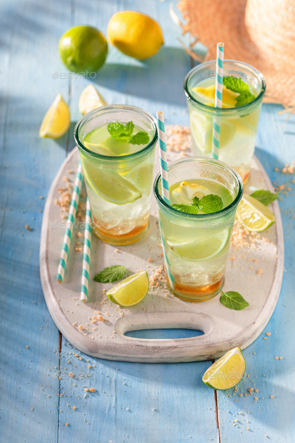Fresh lemonade with sour fruit and crushed ice. Stock Photo by Shaiith