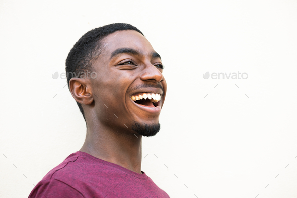 side portrait laughing young black man against white background Stock ...