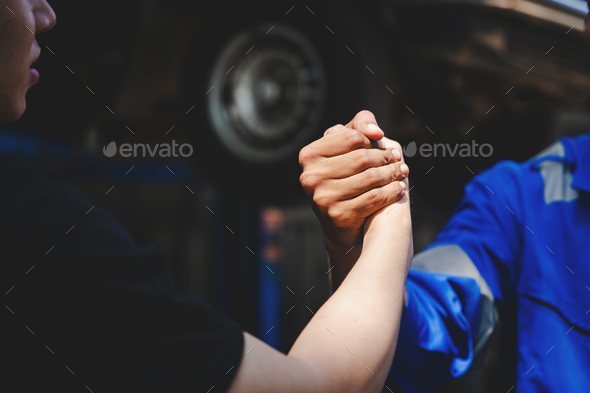 Auto mechanic handshake showing success collaboration of mechanics ...