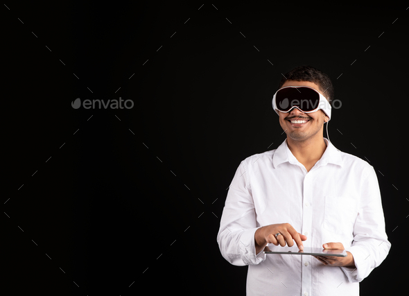 Male CGI artist drawing using graphics tablet and vision pro vr glasses ...