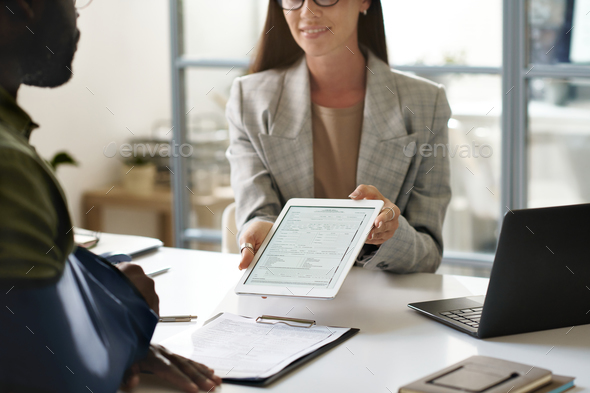 Social worker showing contract to client Stock Photo by Media_photos