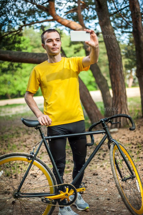 A young man taking a selfie with his Bicycle. Stock Photo by ktkbr-lew