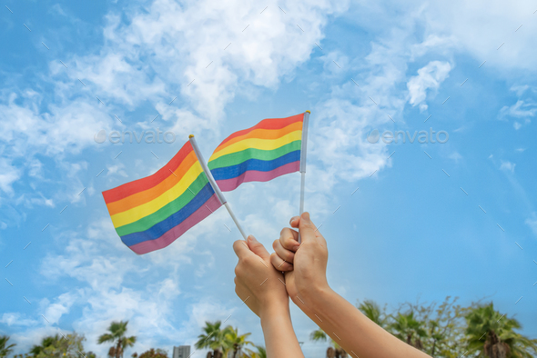 Diversity people hands raising colorful lgbtq rainbow flags together ...