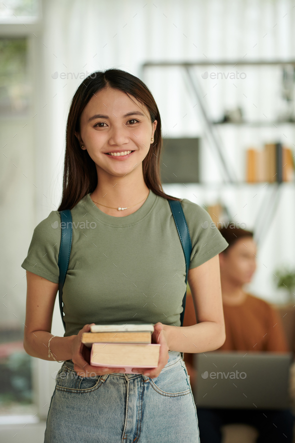 High School Student Holding Books Stock Photo by DragonImages | PhotoDune