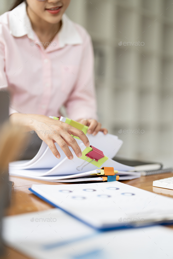 woman hands working in Stacks of paper files for checking unfinished ...
