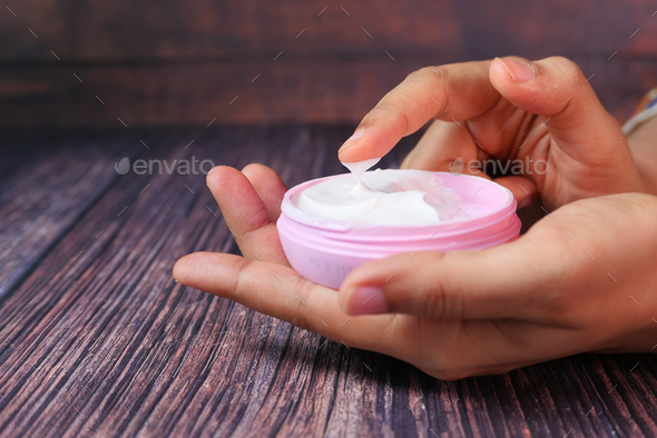 woman applying beauty cream onto skin at home top view Stock Photo by ...