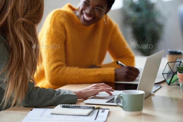 Friends working together using laptop computer college students ...