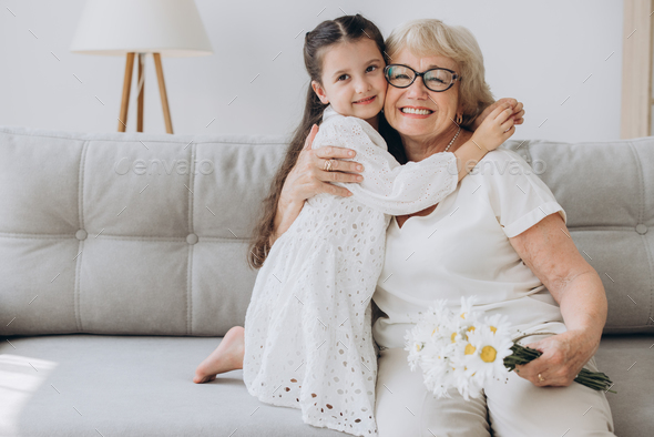 I Love You, Granny. Portrait of cute little girl embracing and kissing ...
