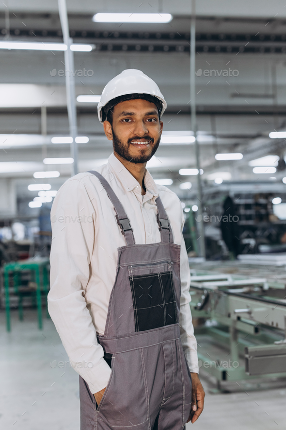Industrial Indian international worker indoors in factory. Young ...