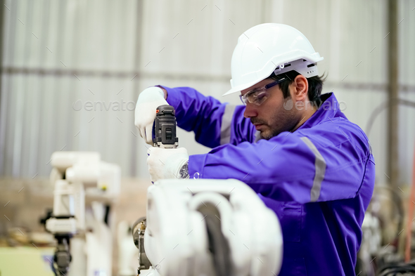 Robotics engineer fitting sensors to traditional engineering lathe in ...