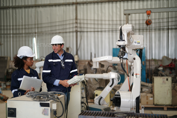 Robotics engineer fitting sensors to traditional engineering lathe in ...