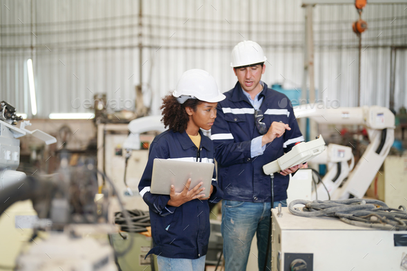Robotics engineer fitting sensors to traditional engineering lathe in ...