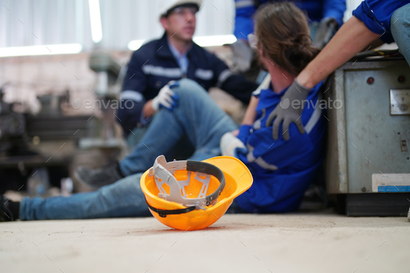 Worker receiving industrial injury in factory Stock Photo by FoToArtist_1