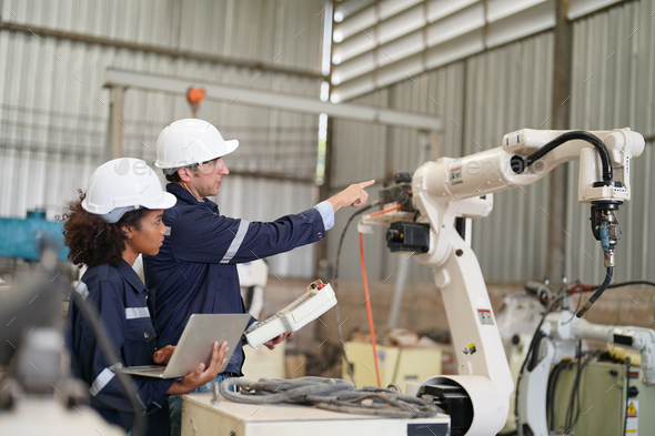 Robotics engineer fitting sensors to traditional engineering lathe in ...