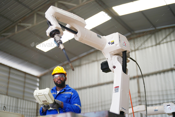 Robotics engineer fitting sensors to traditional engineering lathe in ...