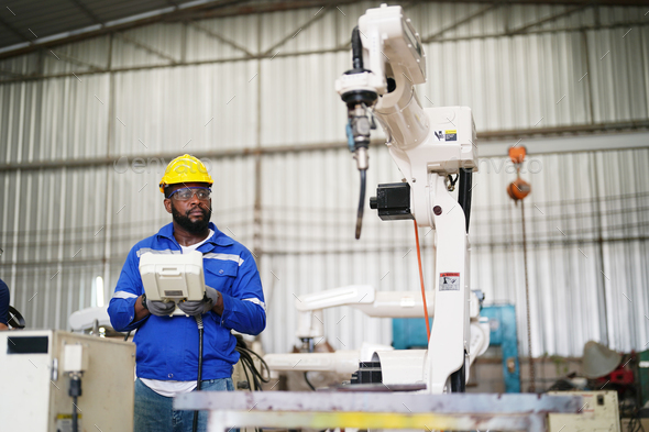 Robotics engineer fitting sensors to traditional engineering lathe in ...