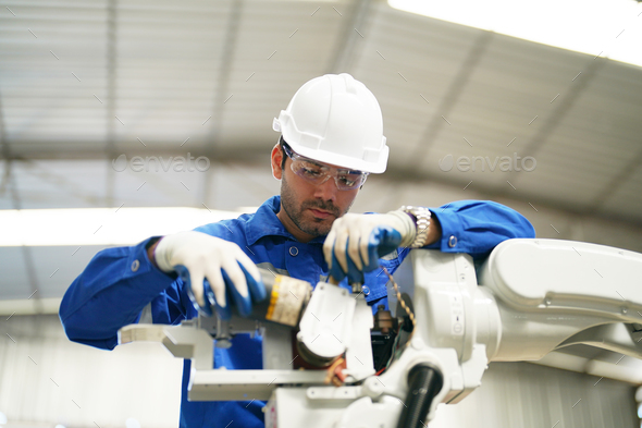 Robotics engineer fitting sensors to traditional engineering lathe in ...
