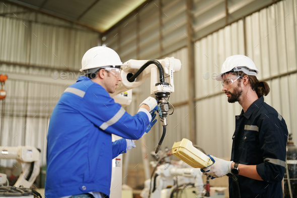 Robotics engineer fitting sensors to traditional engineering lathe in ...