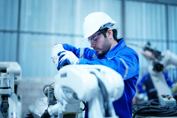 Robotics engineer fitting sensors to traditional engineering lathe in ...