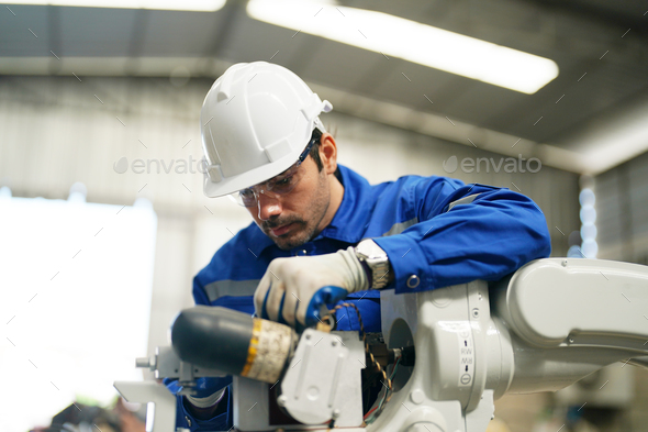 Robotics engineer fitting sensors to traditional engineering lathe in ...