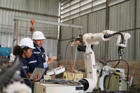Robotics engineer fitting sensors to traditional engineering lathe in ...