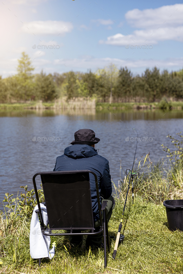 fishing rod on lake water background. Man catching fish by spinning on ...