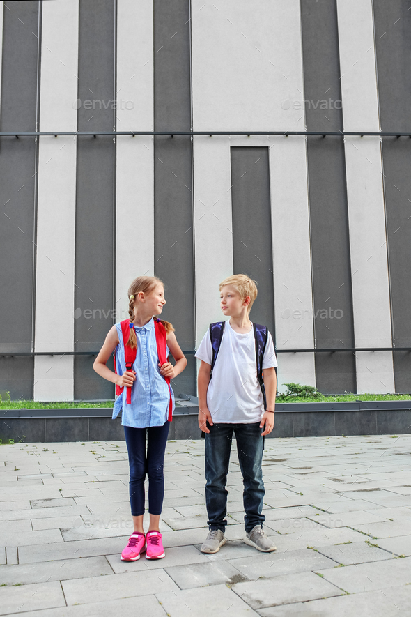 Back to school. Classmates backpack behind back. Children go to school ...