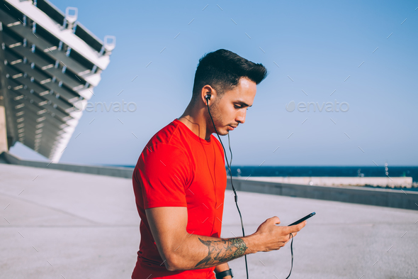 Man in modern headphones listening radio set during time for urbanity ...