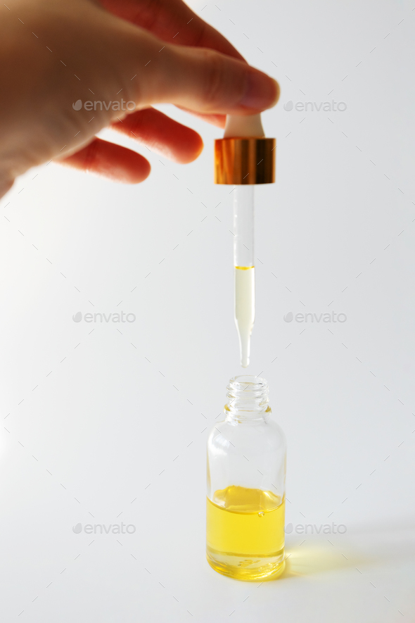 Serum in glass bottle and human hand holding pipette Stock Photo by ...