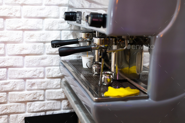 Professional coffee brewing. Espresso machine preparing and pouring two ...