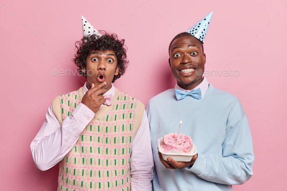 Birthday celebration. Two young guys surprised Hindu and happy smiling ...