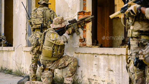 Smart teamwork of soldiers running forward and attacking enemy during ...