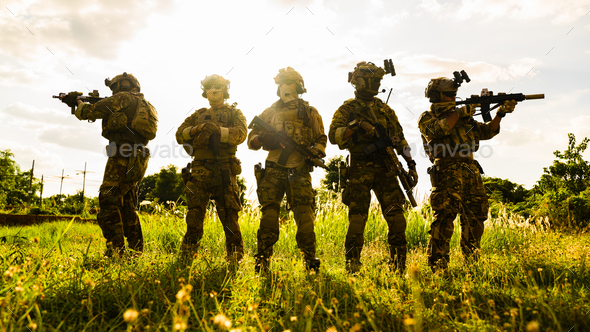 Smart teamwork of soldiers running forward and attacking enemy during ...