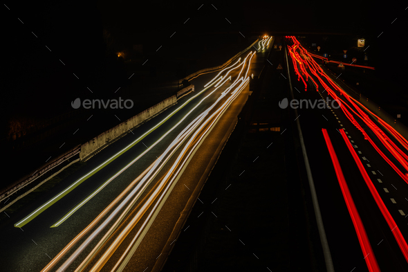 Abstract image of night traffic lights on the road. Car light trails at ...