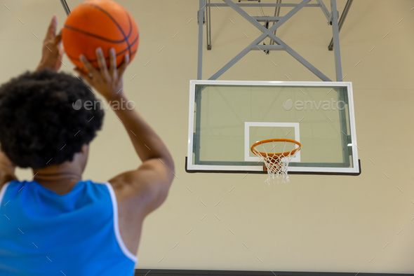 Biracial male basketball player wearing blue sports clothes and ...