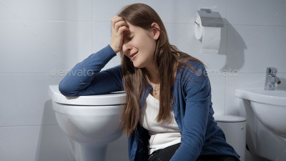 Crying young woman having problems and stress in life sitting on floor ...