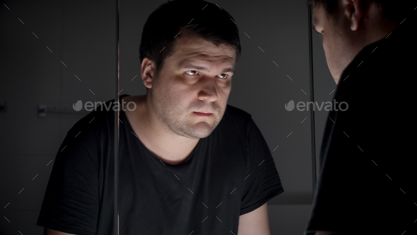 Angry frustrated man looking at his reflection in mirror. Concept of ...