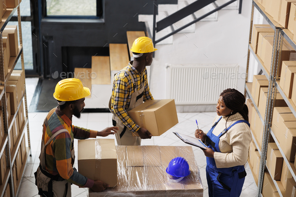 Warehouse loaders lifting parcels ready for shipment Stock Photo by DC ...