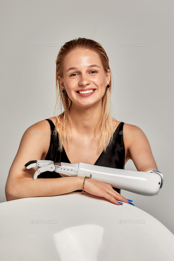 Young charming girl with disability wearing sensory bionic prosthetic ...
