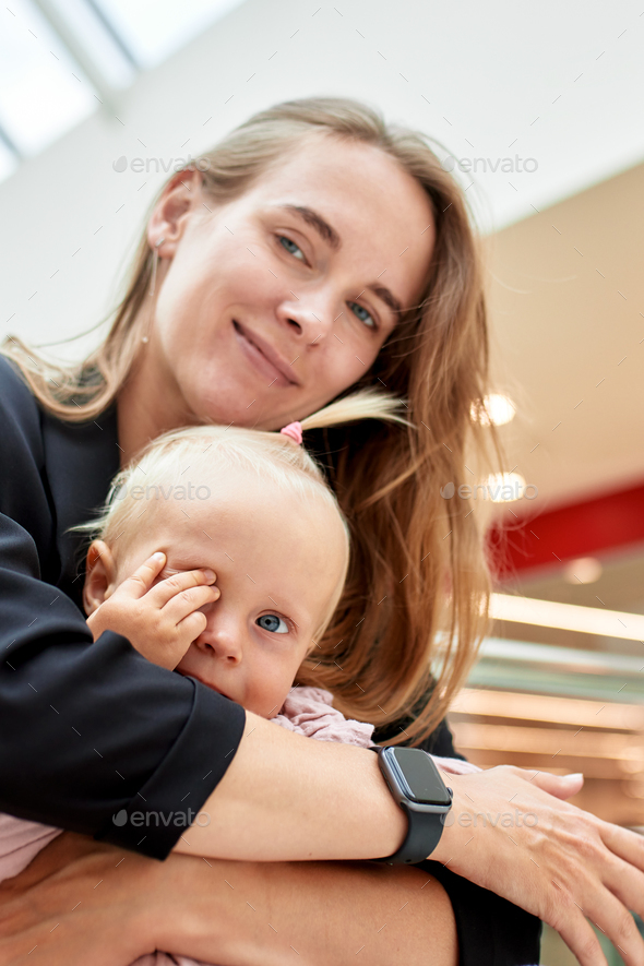 Close-up portrait of young pretty mother hugging her cute little baby ...