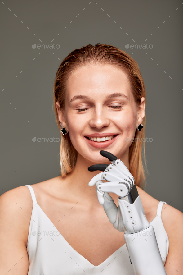 Close up studio portrait of charming young girl in white dress wearing ...