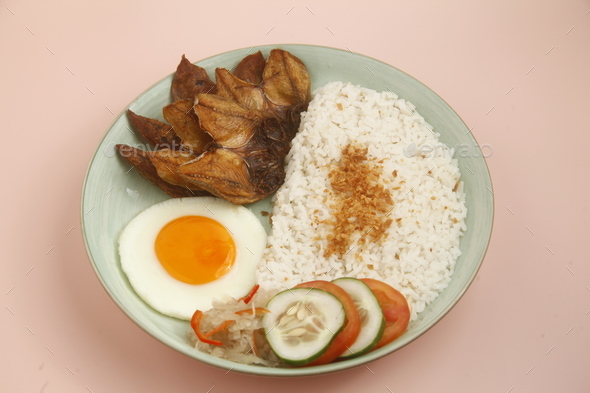 Freshly cooked Filipino food called Daing Silog Stock Photo by junpinzon