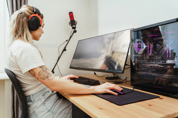 Girl professional esports athlete playing video game on her modern ...