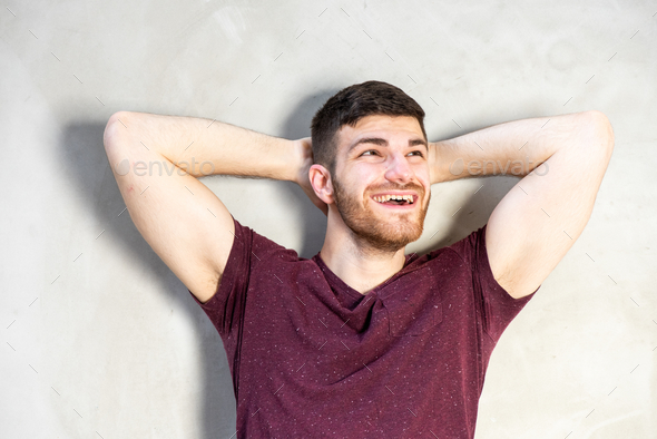 Close up happy young man laughing with hands behind head Stock Photo by ...