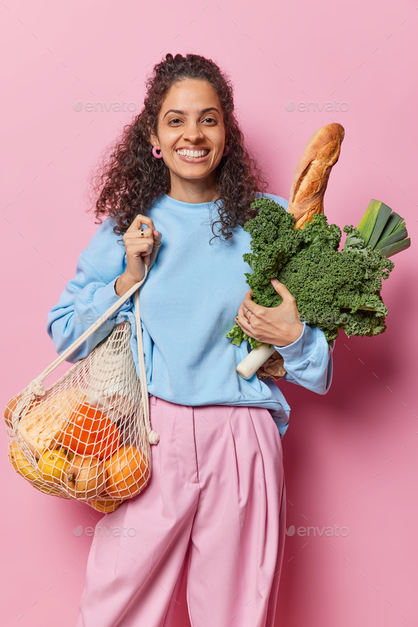 Brazilian woman returns from supermarket holding grocery bag filled ...