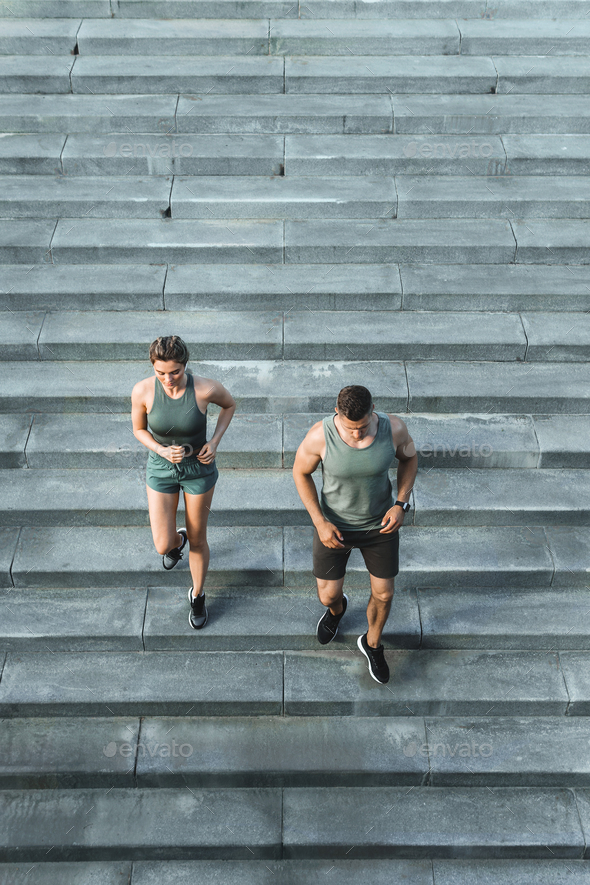 Sportive couple during workout stair running outdoors Stock Photo by ...