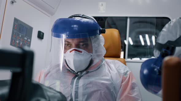 Exhausted Paramedic Riding Ambulance with Colleague, Stock Footage