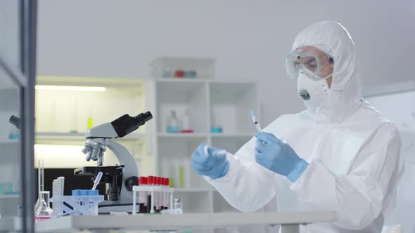 Medical Scientist Flicking Syringe in Laboratory, Stock Footage | VideoHive