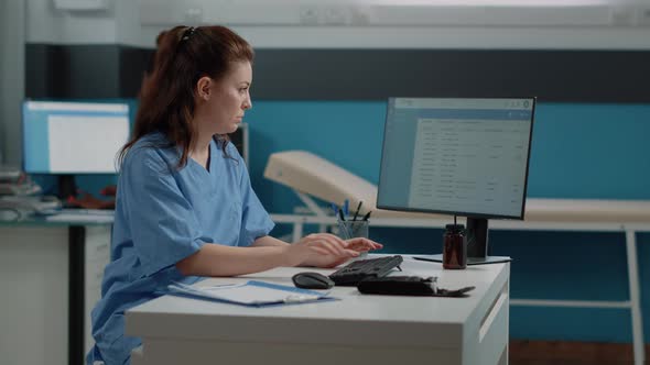 Medical Assistant Working on Computer with Patient Information, Stock ...